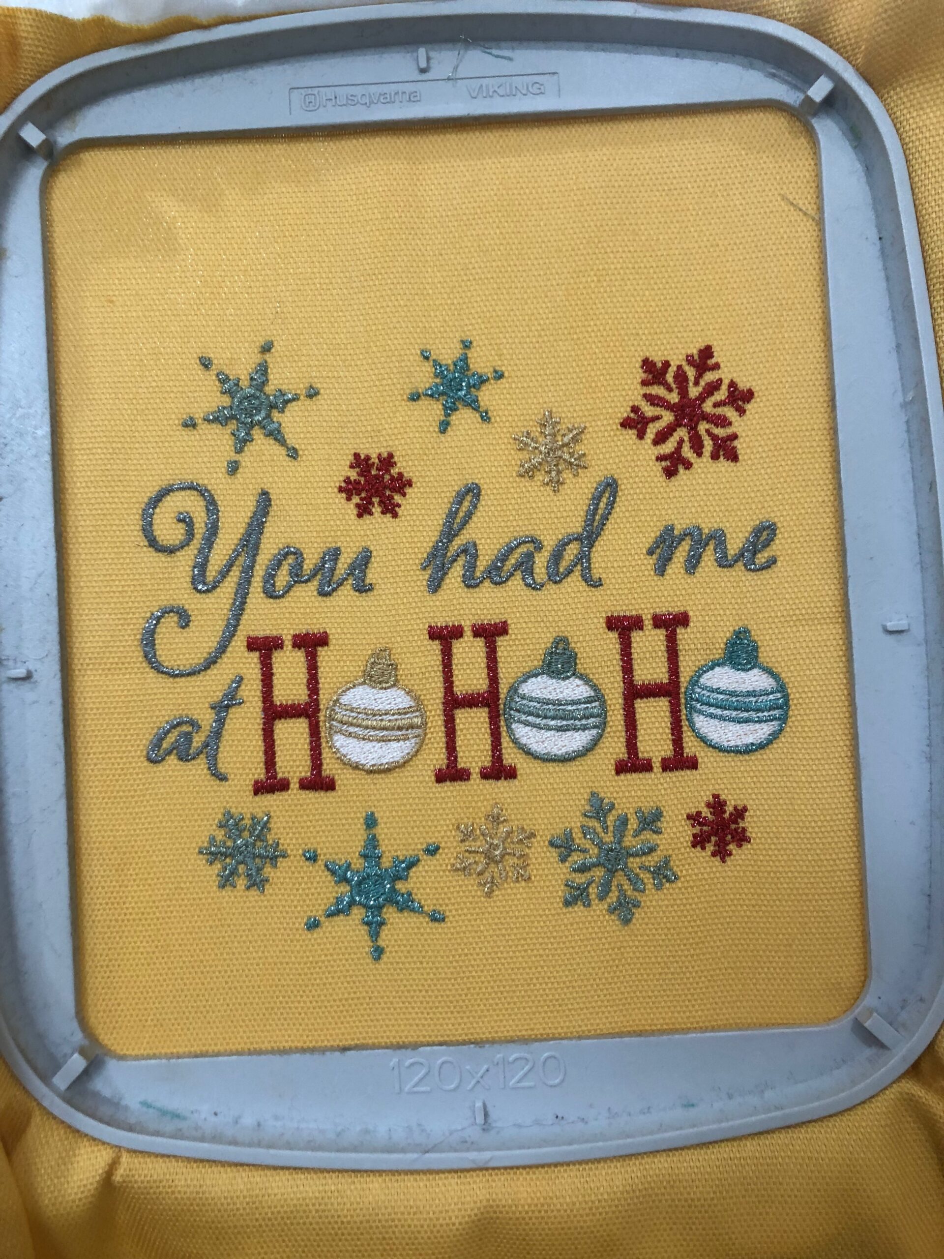 Festive yellow bag with 'You had me at HO HO HO' and snowflake designs ...