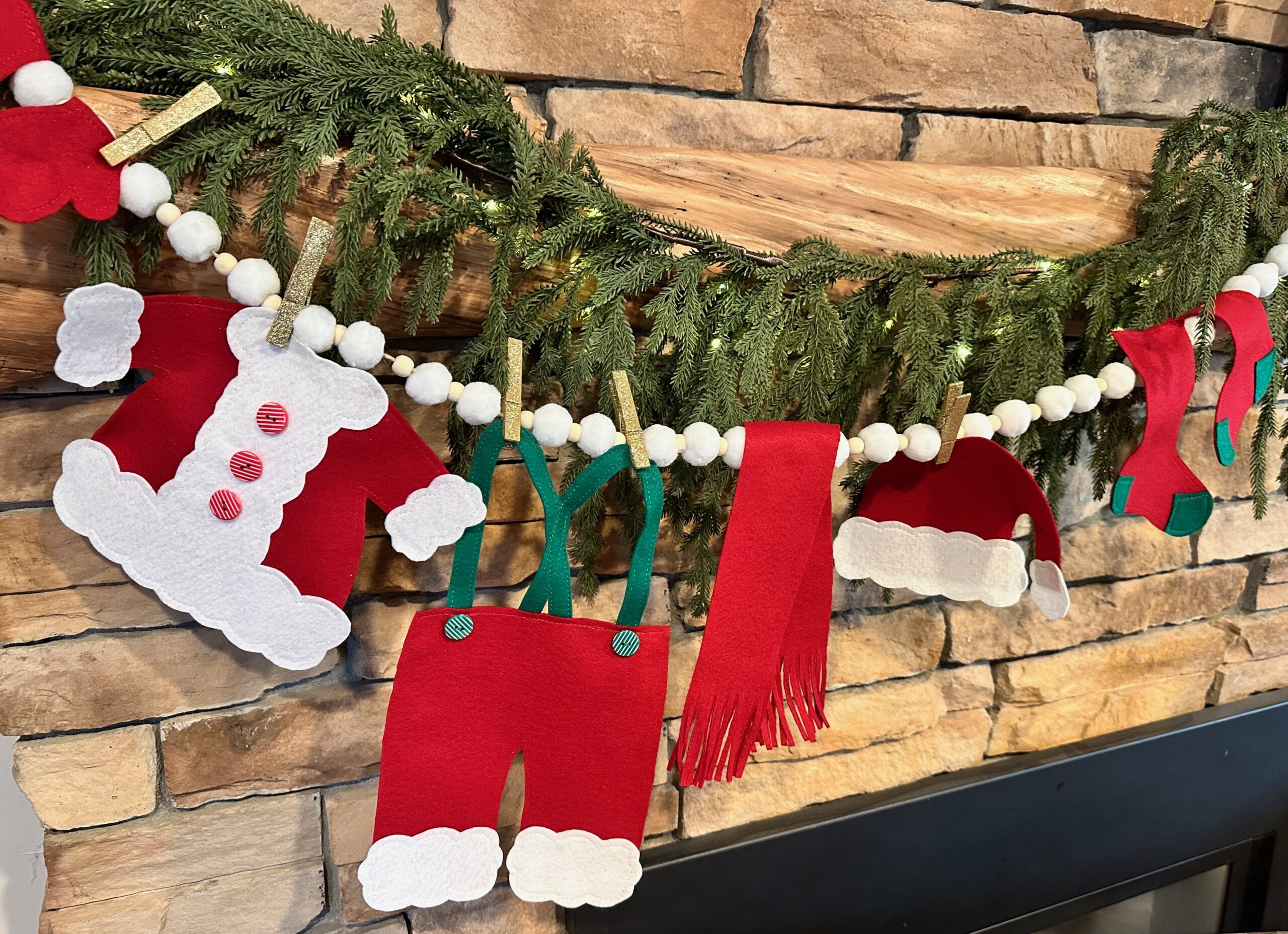 Santa's wardrobe clothesline on garland on mantel - Sulky